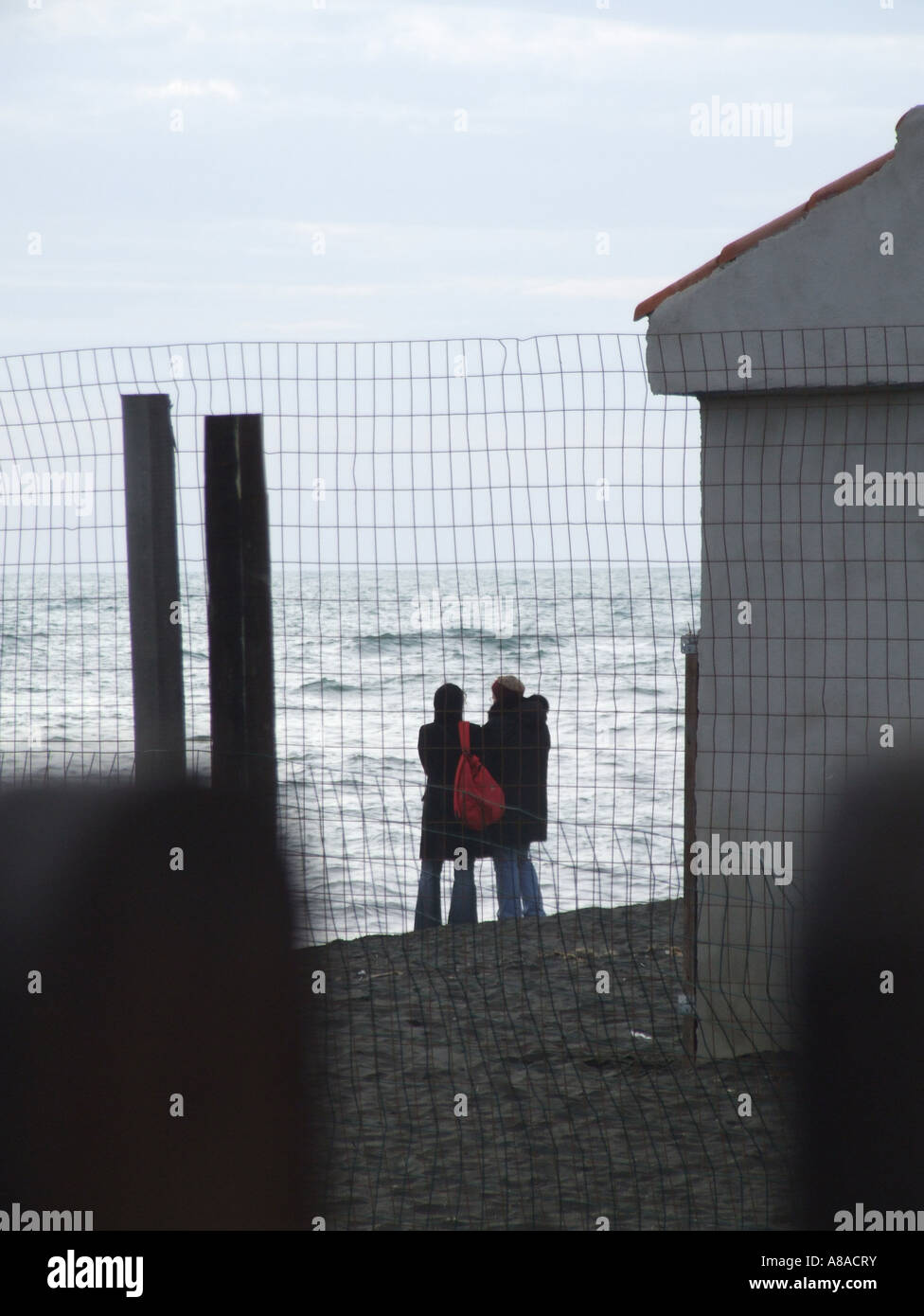 two people standing by beach in winter Stock Photo - Alamy