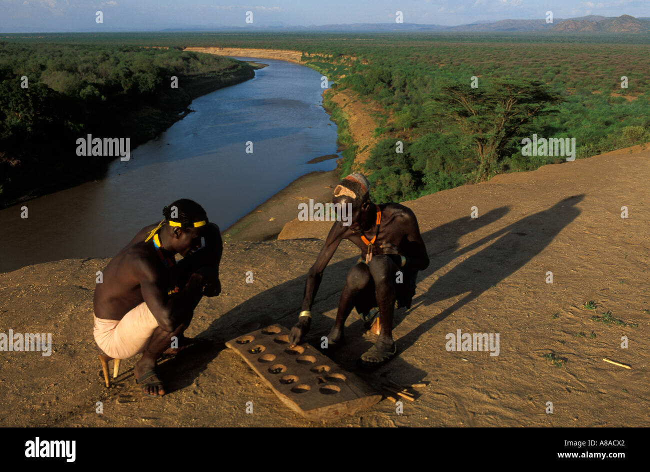 Karo men playing bao game at the Omo river , Kolcho , South Omo Valley ...
