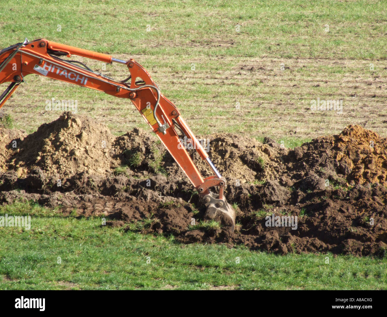 mechanical digger digging hole Stock Photo - Alamy