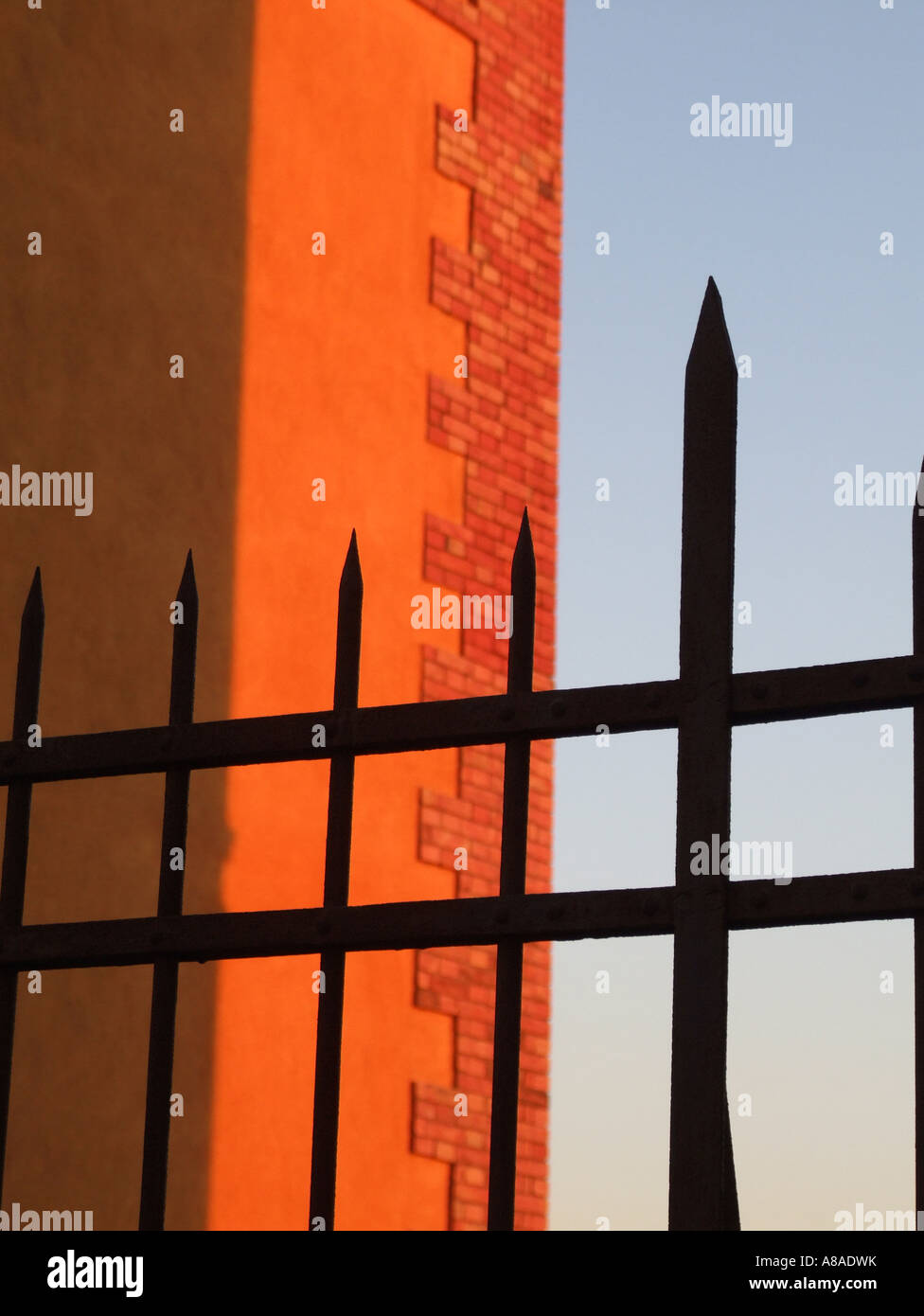 high fence and building Stock Photo - Alamy