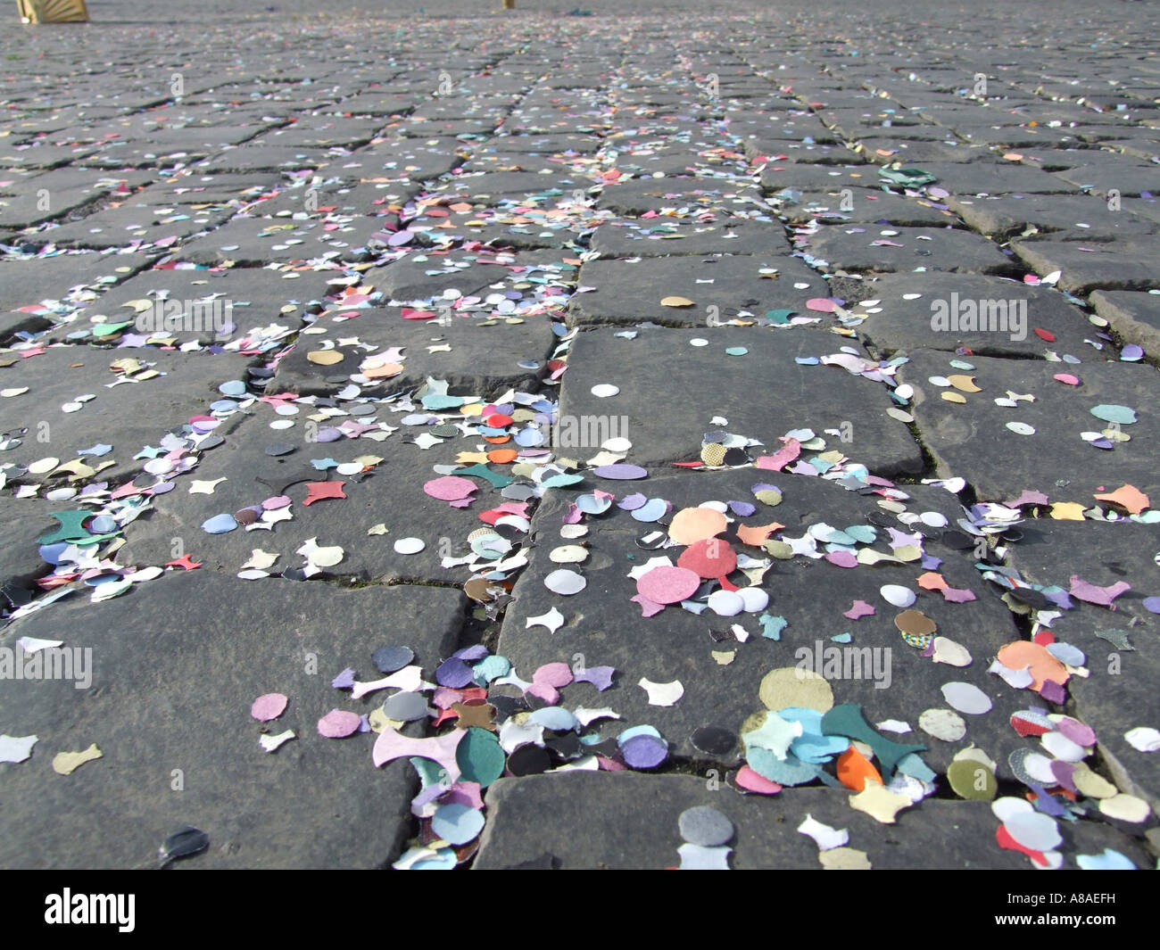 confetti and garlands on cobbled street Stock Photo - Alamy