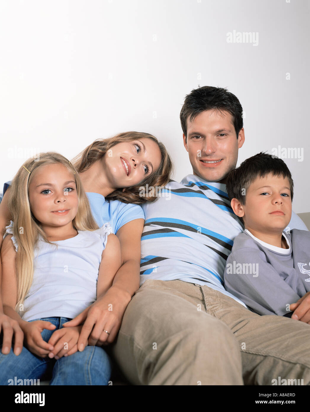 Family sitting together Stock Photo - Alamy