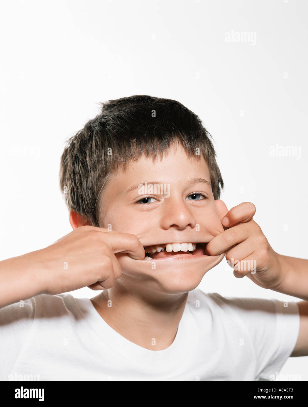 Boy pulling face Stock Photo - Alamy