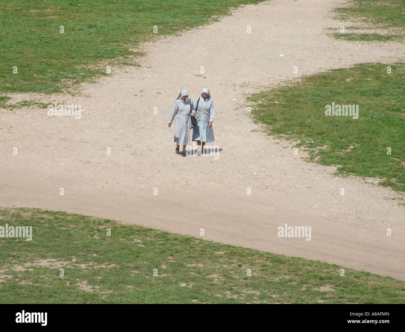 two nuns walking on path in rome Stock Photo - Alamy