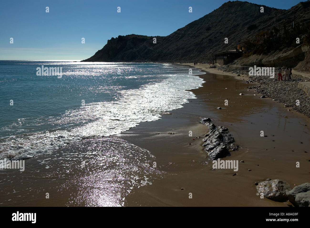 Sandy beach scene nicely backlit with good waves and blue sky at Burgau ...