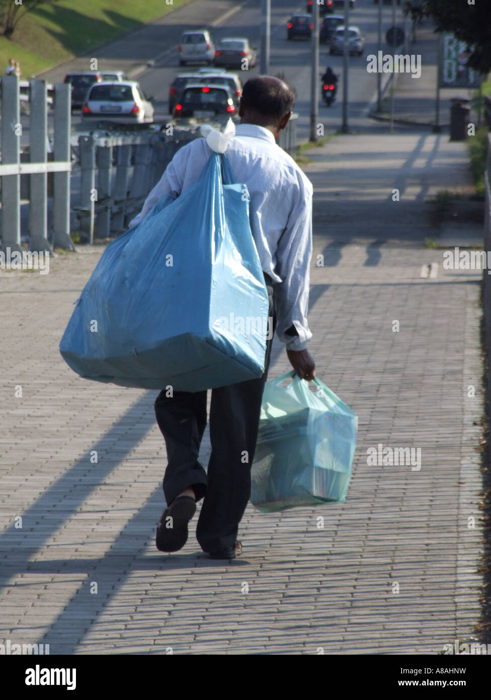 street vendor immigrant carrying goods in rome Stock Photo - Alamy