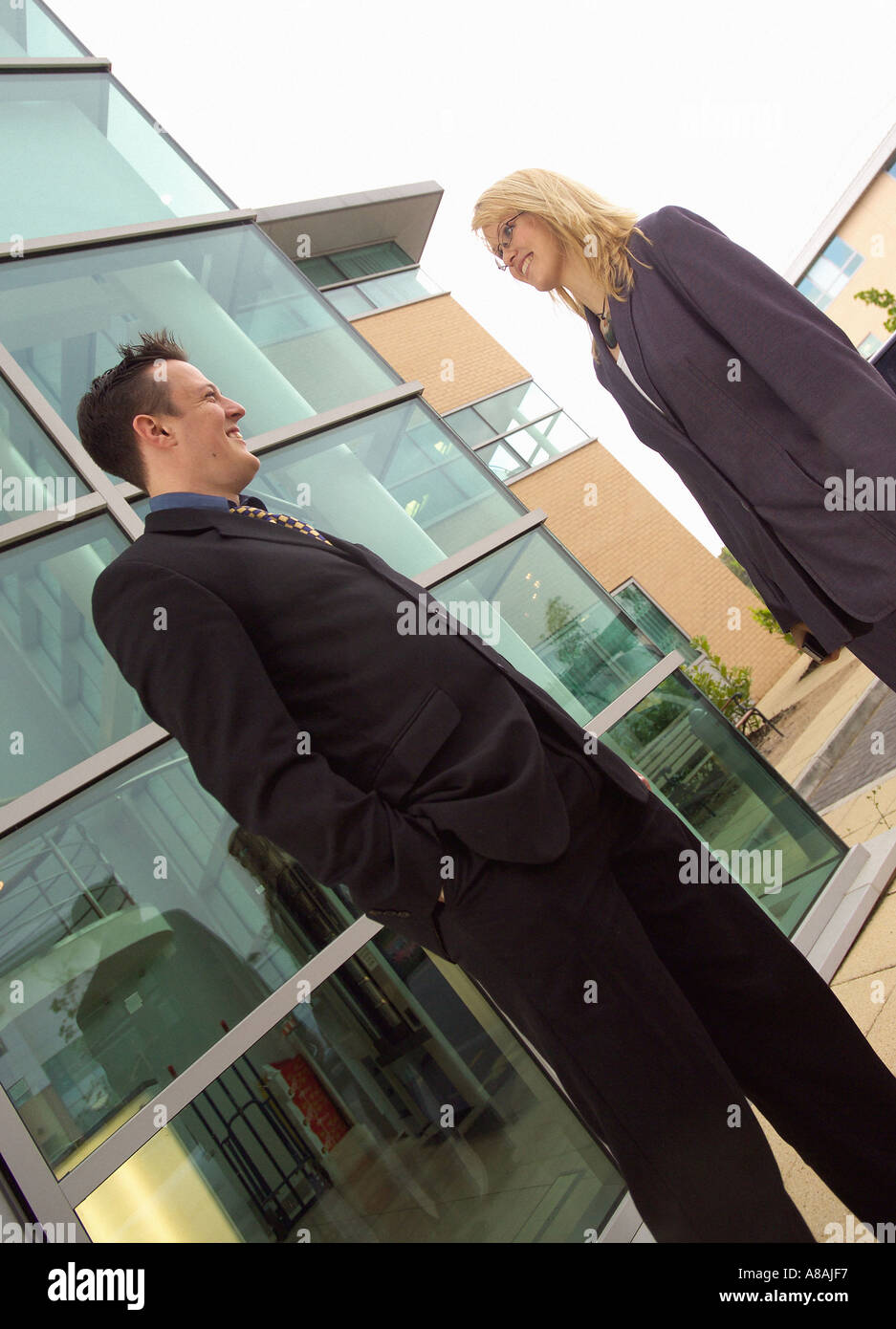 Angled shot of business professionals in smart suits facing each other ...