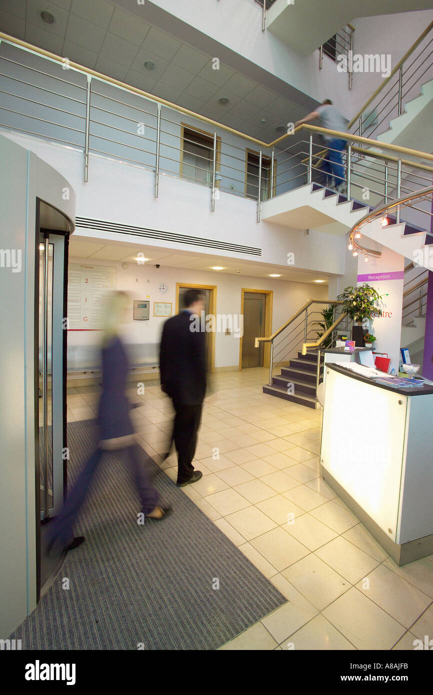 Reception desk in the foyer of an office building with blurred, smartly ...