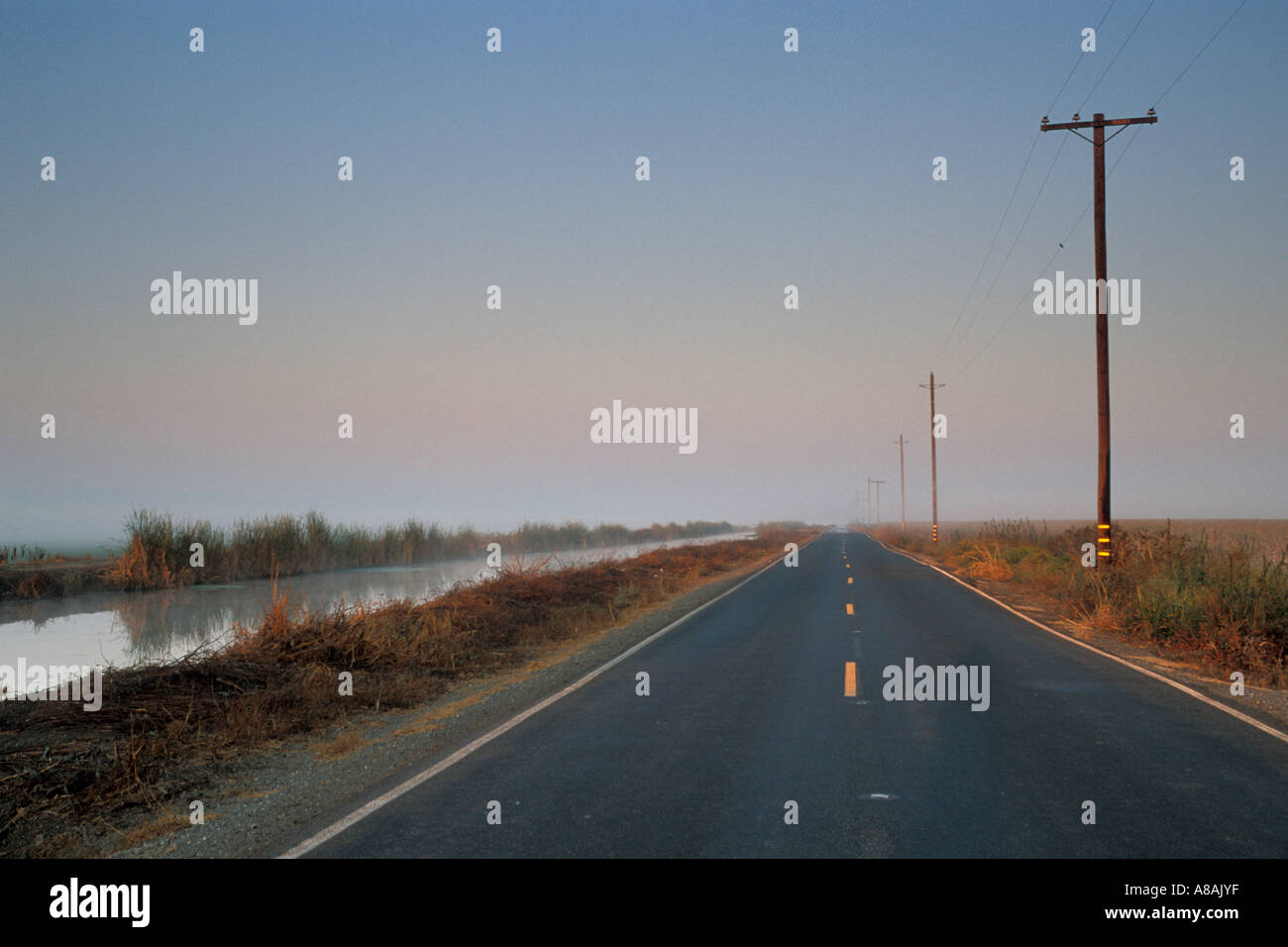 Narrow two lane long straight rural levee road Jones Tract San Joaquin ...