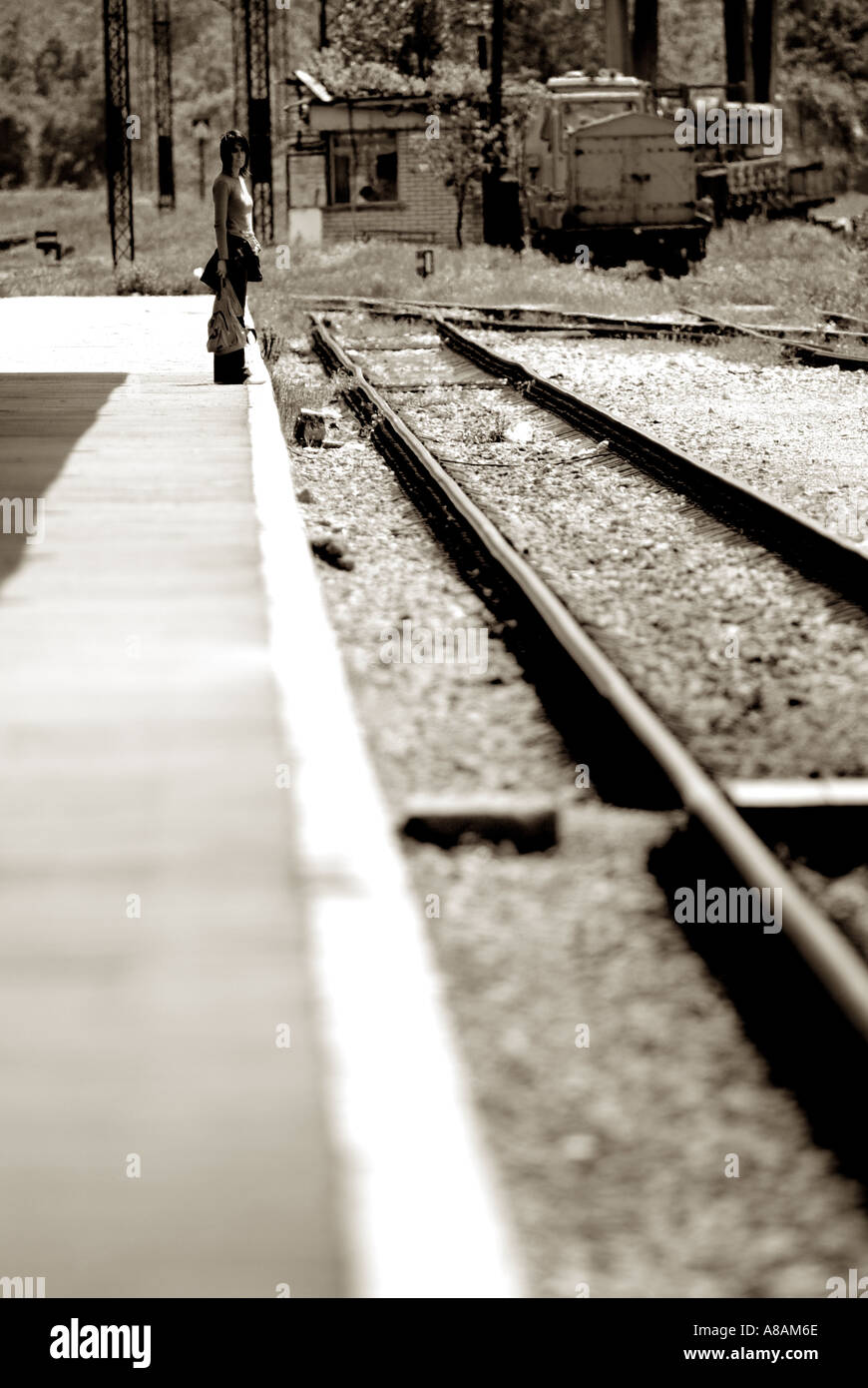 Young Woman Standing at the End of a Train Station Platform Stock Photo ...