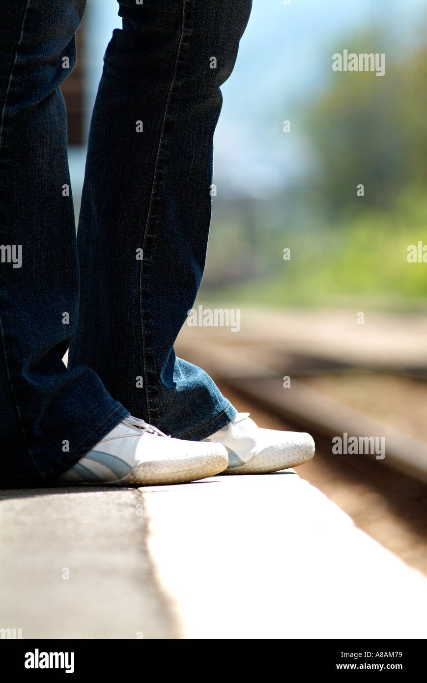 Woman Standing on the Edge of a Train Platform at a Railway Station ...