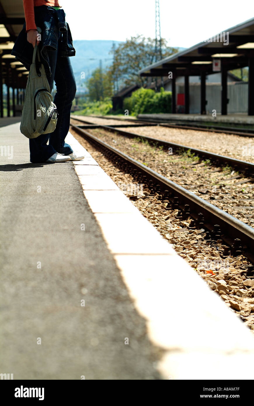 Woman Standing on the Edge of a Train Platform at a Railway Station ...