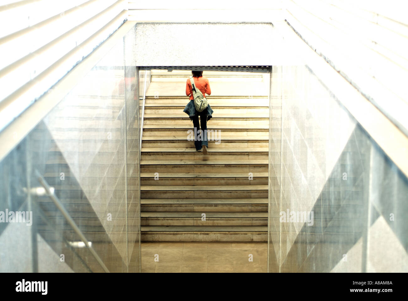 Young Woman Going Up the Steps from the Subway Stock Photo - Alamy