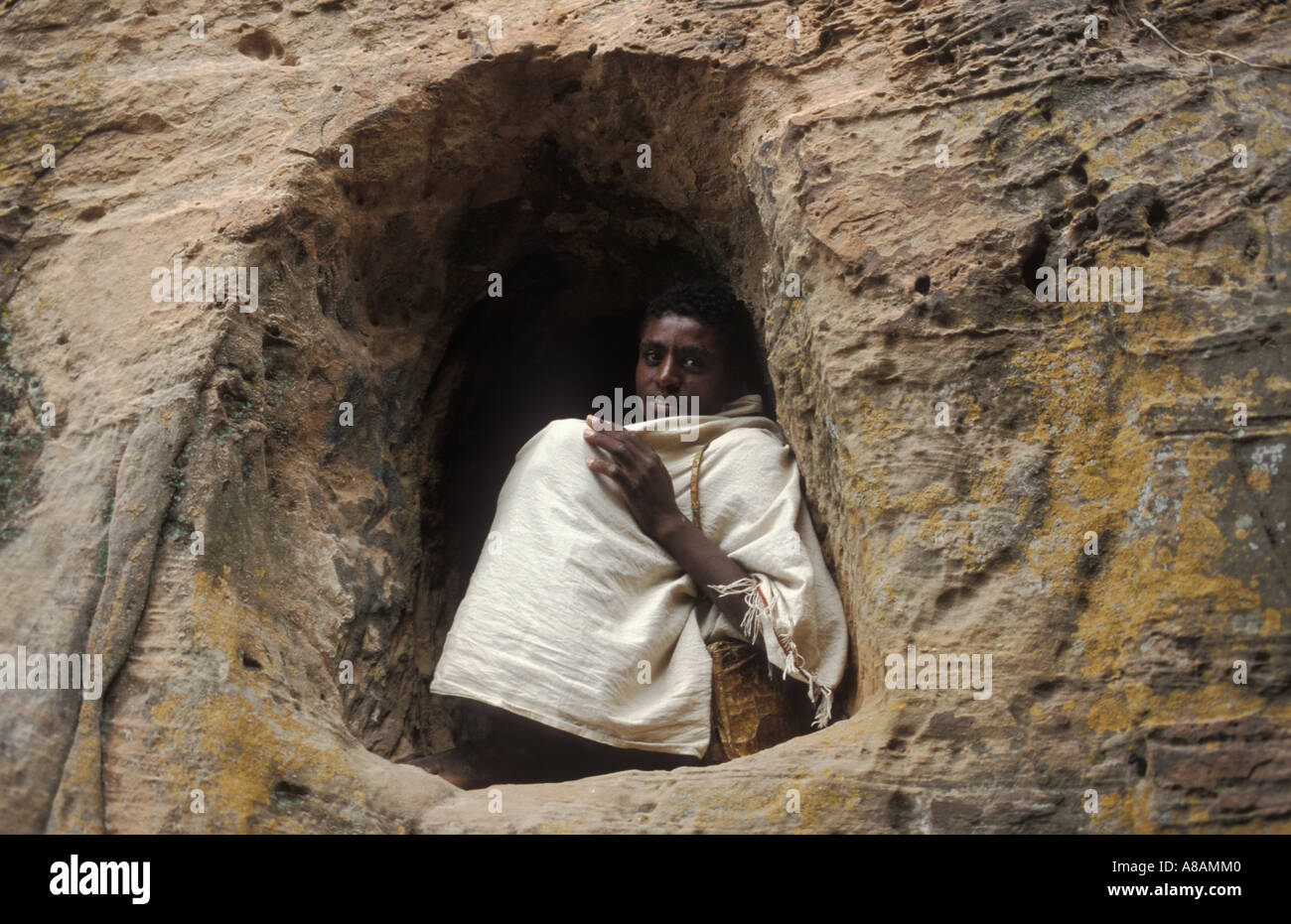 boy sitting in a cave , Abba Yohanni rock-hewn monastery , the Tembien ...