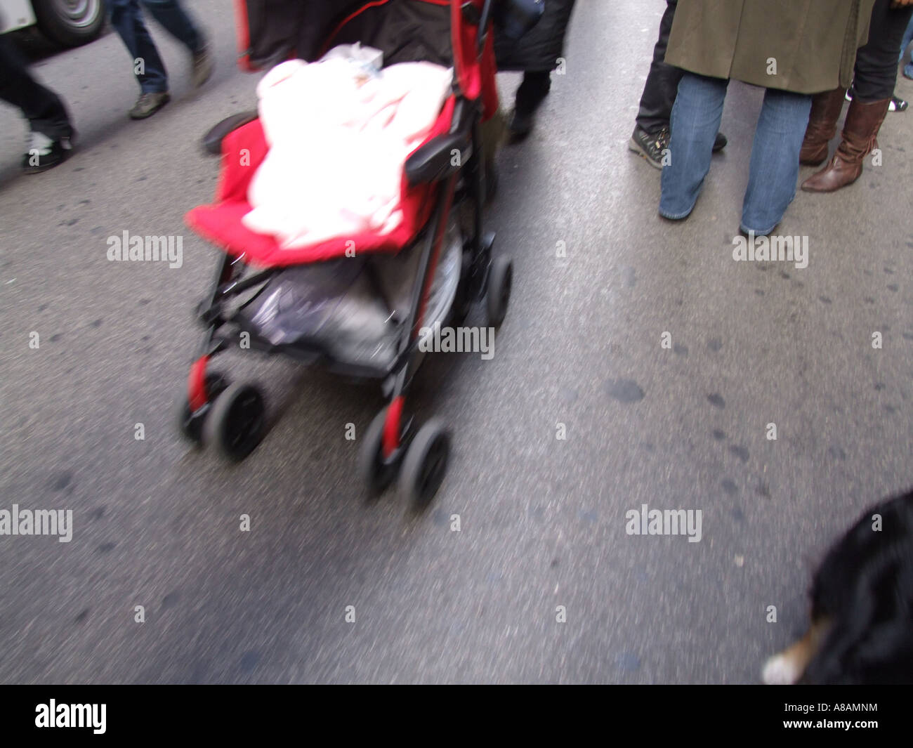 person pushing empty baby pram in sun in street in town Stock Photo - Alamy