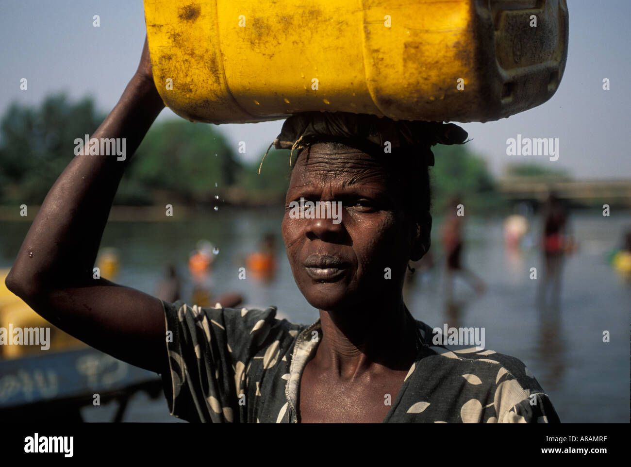Woman collecting water from the Baro river , Gambella , Ethiopia Stock ...