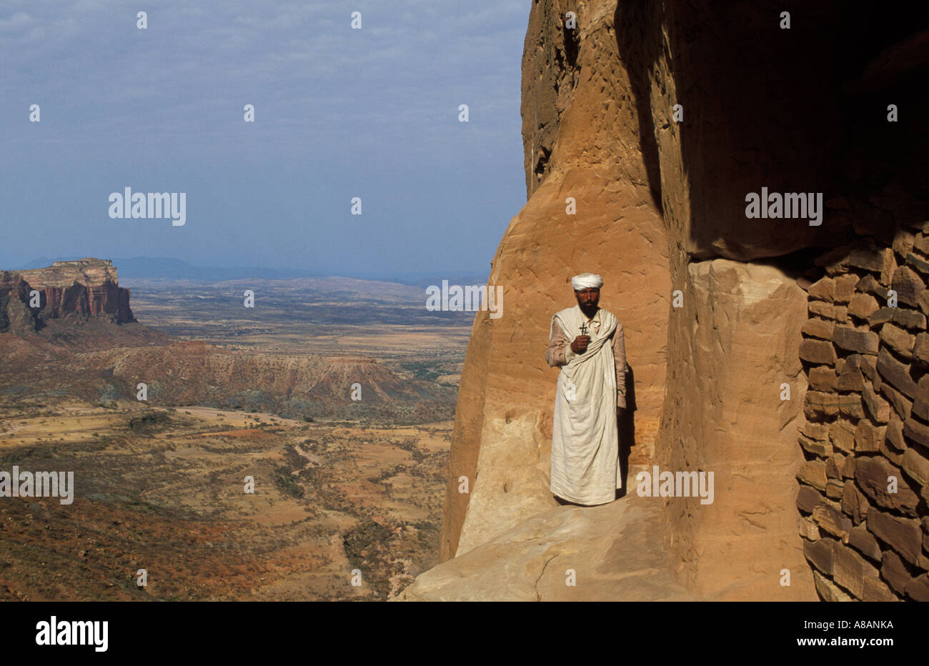 Priest on cliff entrance of Abuna Yemata Guh rock-hewn church ...