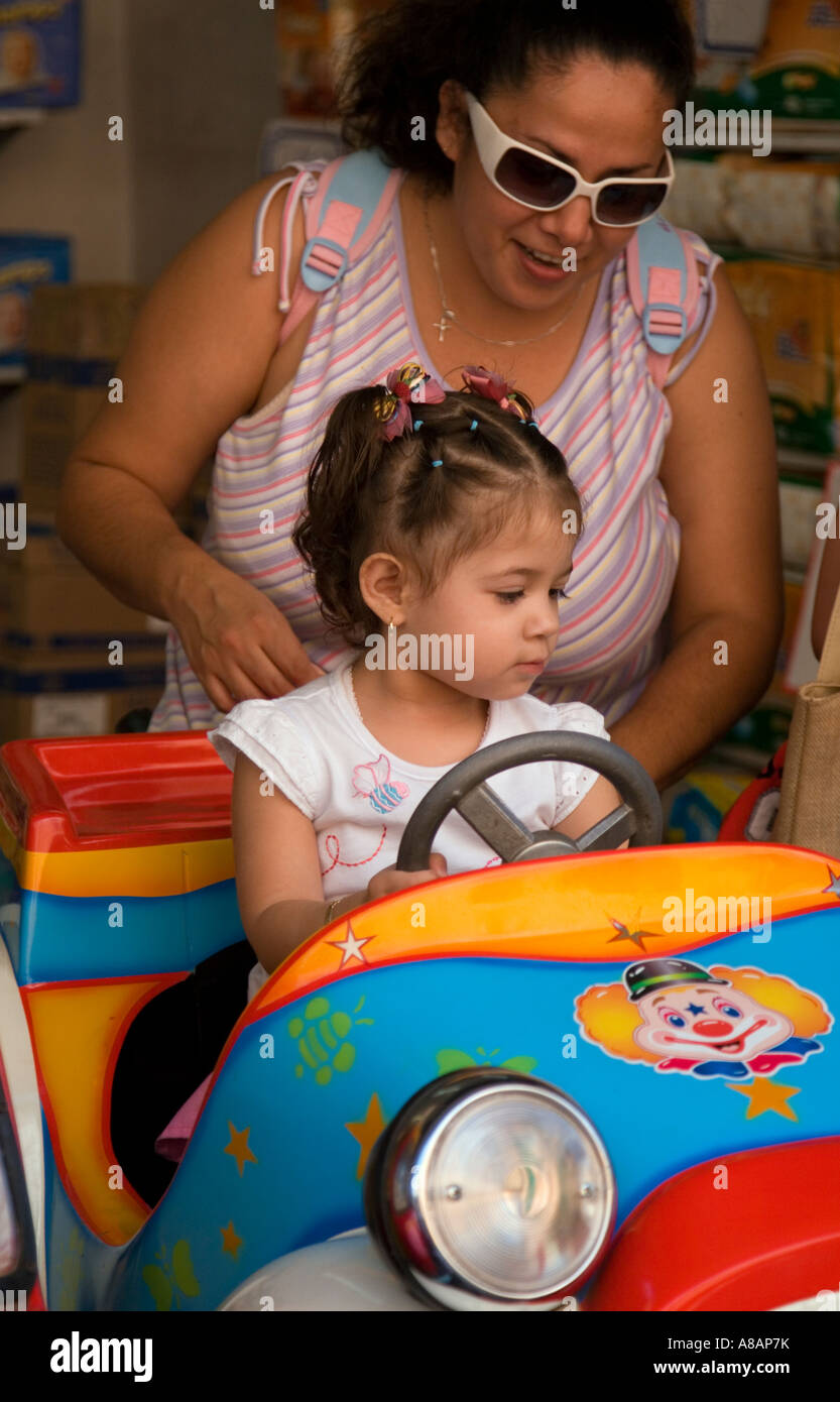 A MEXICAN MOTHER and CHILD in a TOY CAR RIDE GUANAJUATO MEXICO Stock ...