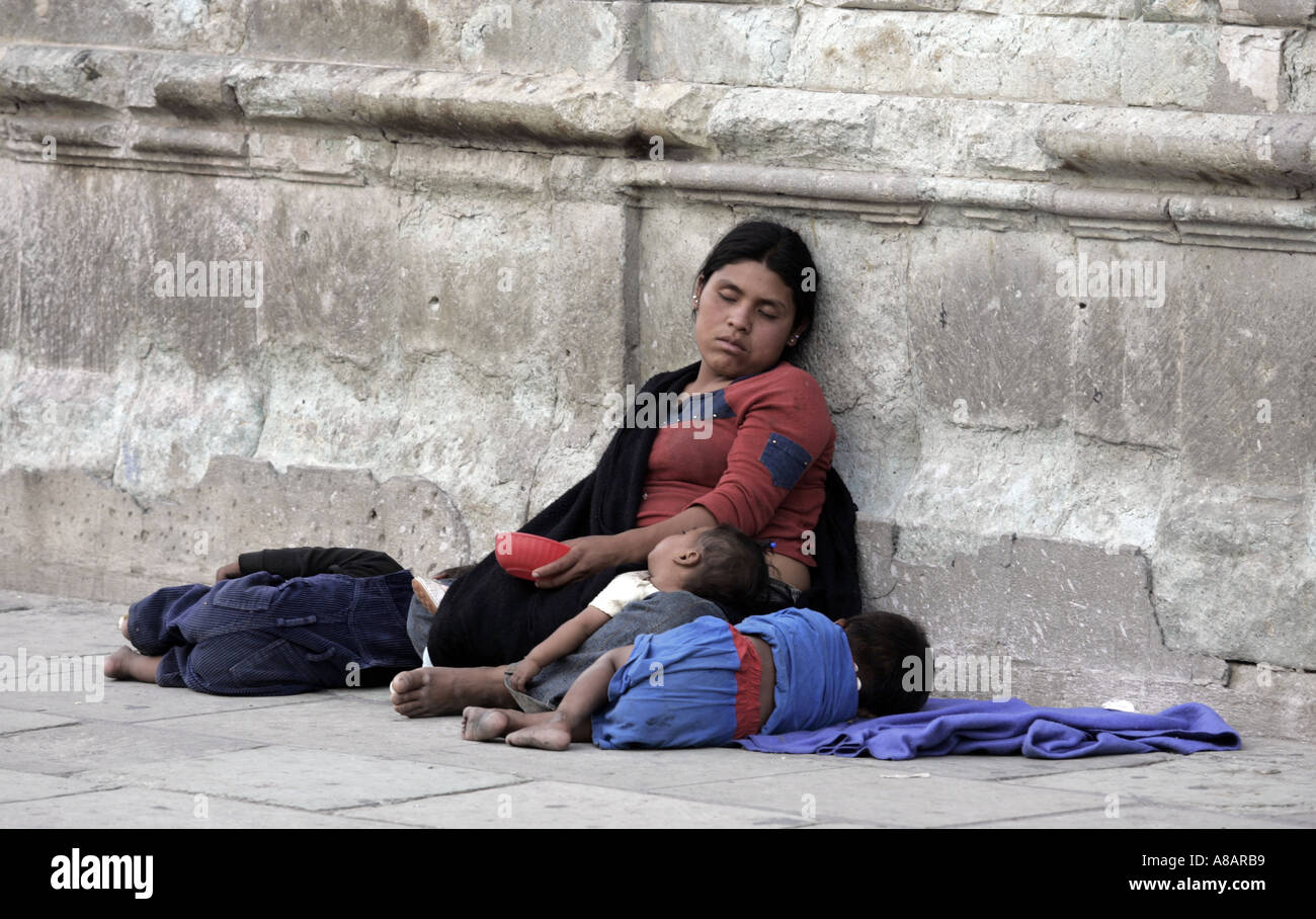 A destitute woman and her children asleep in a street of Oaxaca Mexico ...