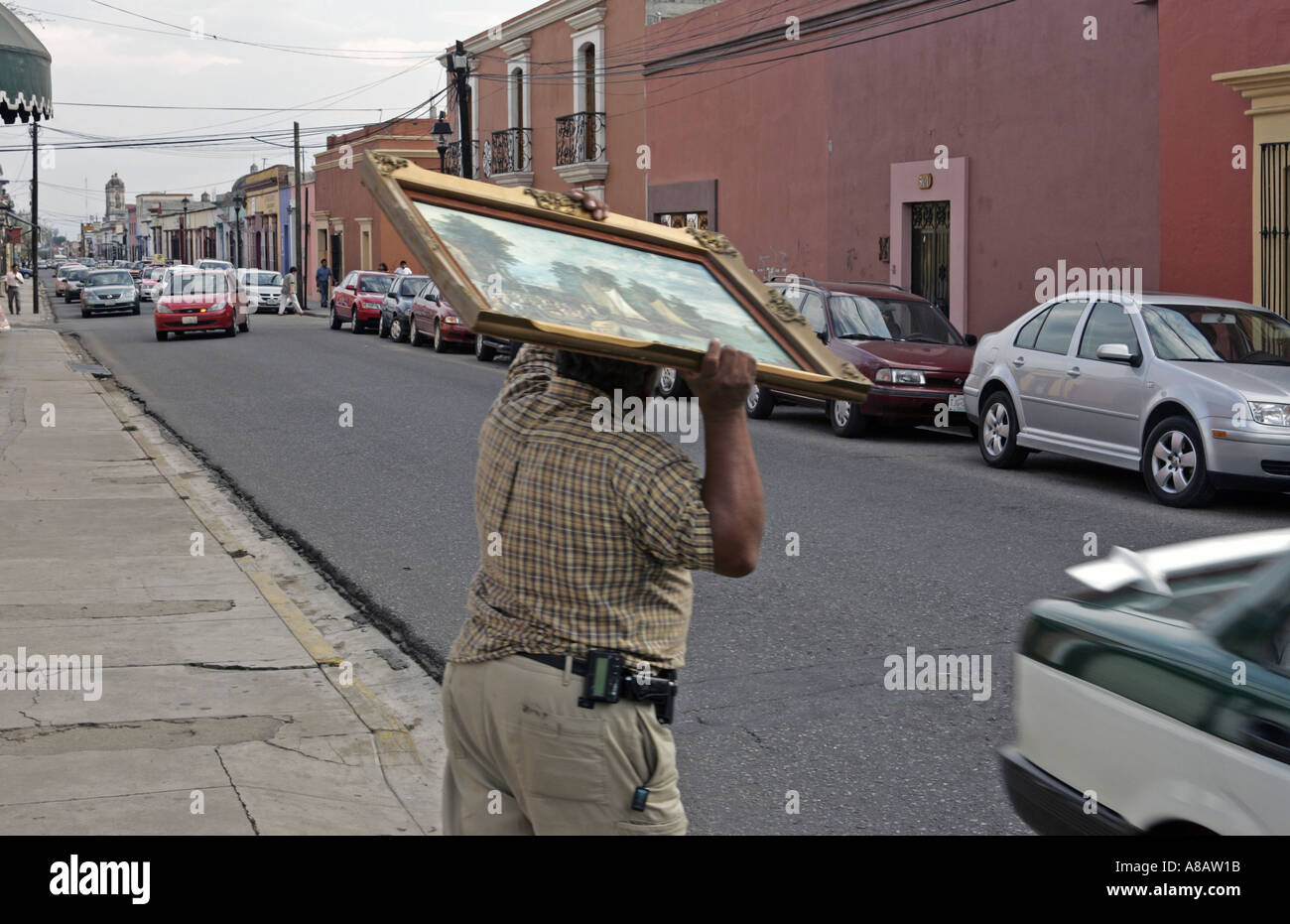 Man carrying a framed painting in a street of Oaxaca Mexico Stock Photo ...