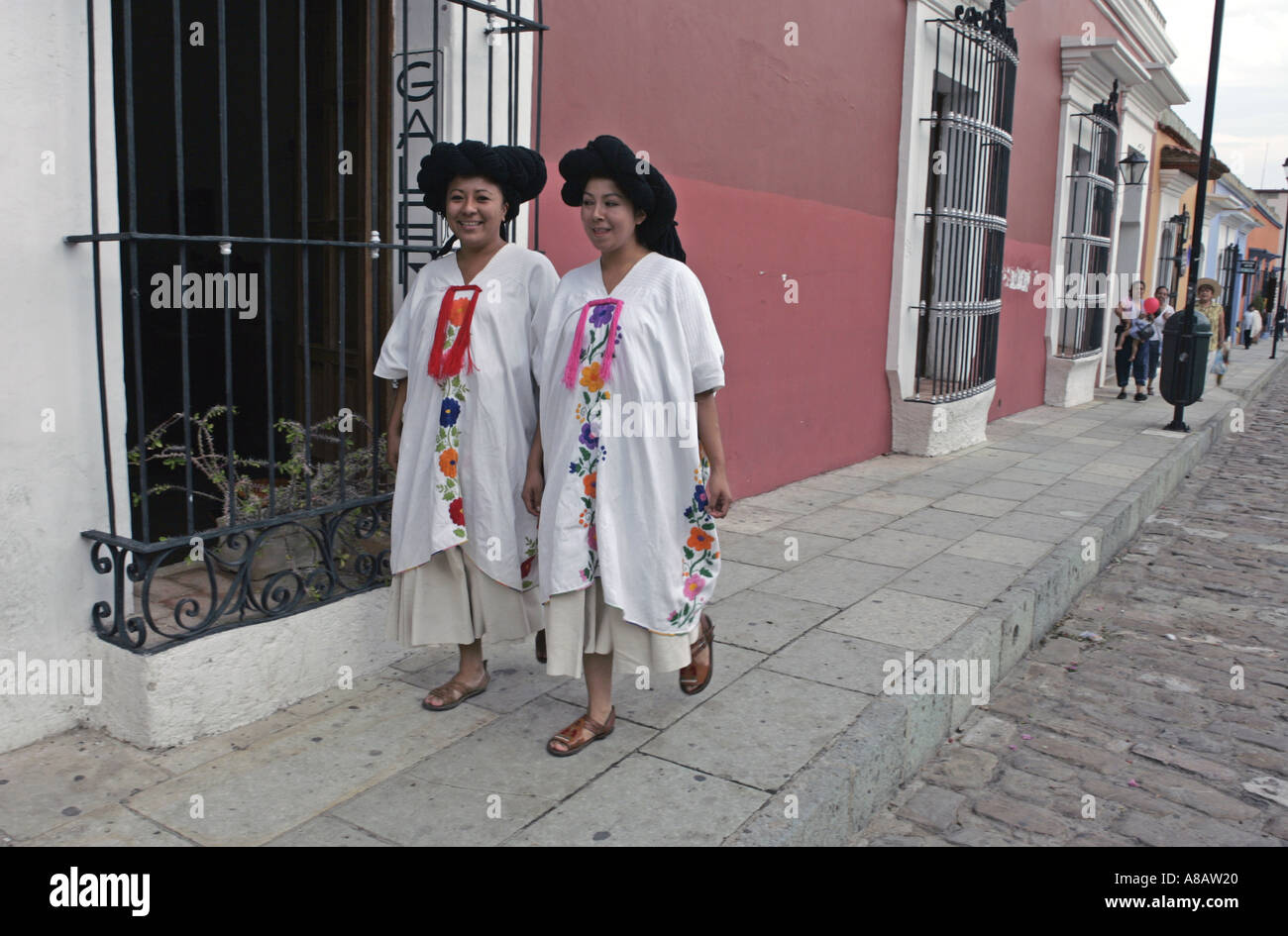 Two women wearing traditional outfits in a street of the historic ...
