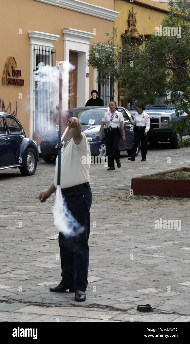 A man shoots some fireworks in a street of Oaxaca Mexico in celebration ...