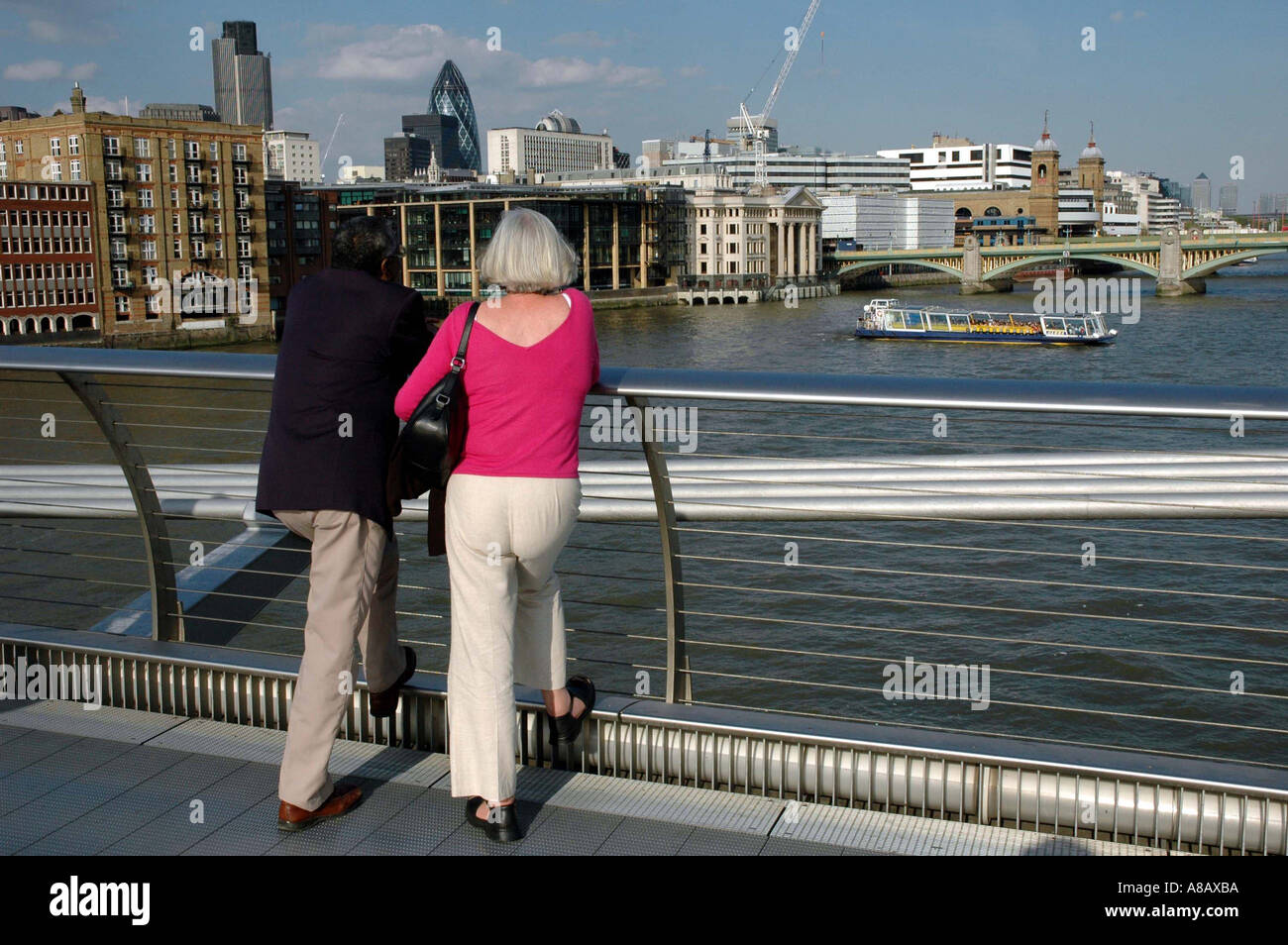 COUPLE GAZE AT THE THAMES LONDON UK FROM THE MELLINIUM BRIDGE Stock ...