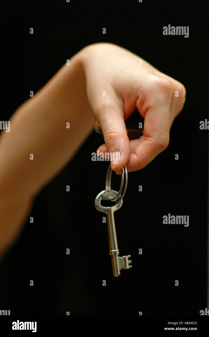 Hand holding a key Stock Photo - Alamy