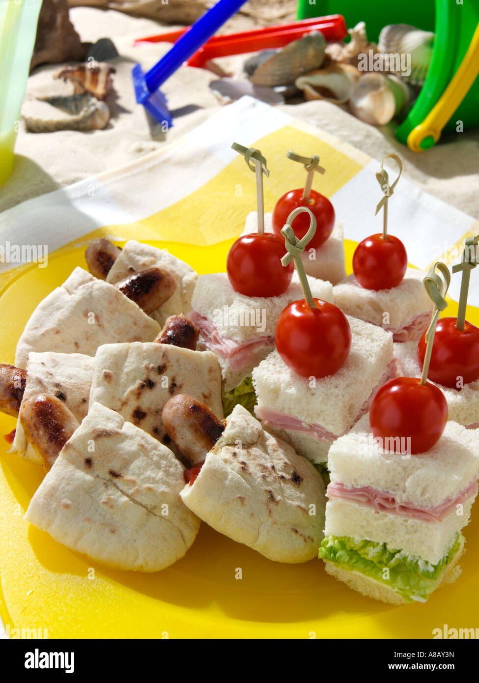 A plate of mini club sandwiches and chipolata sausages pita breads at a ...