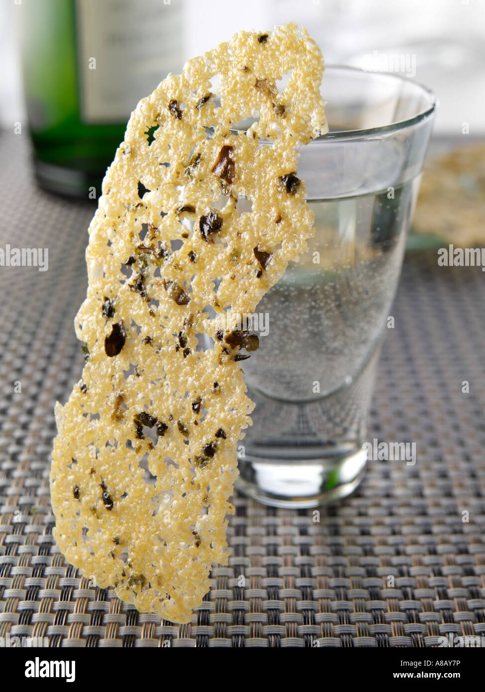 Seaweed cheese wafer and a glass of white wine Stock Photo - Alamy