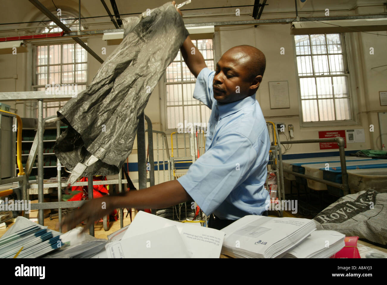 A postman at a Royal Mail sorting office Deptford, south London. UK ...
