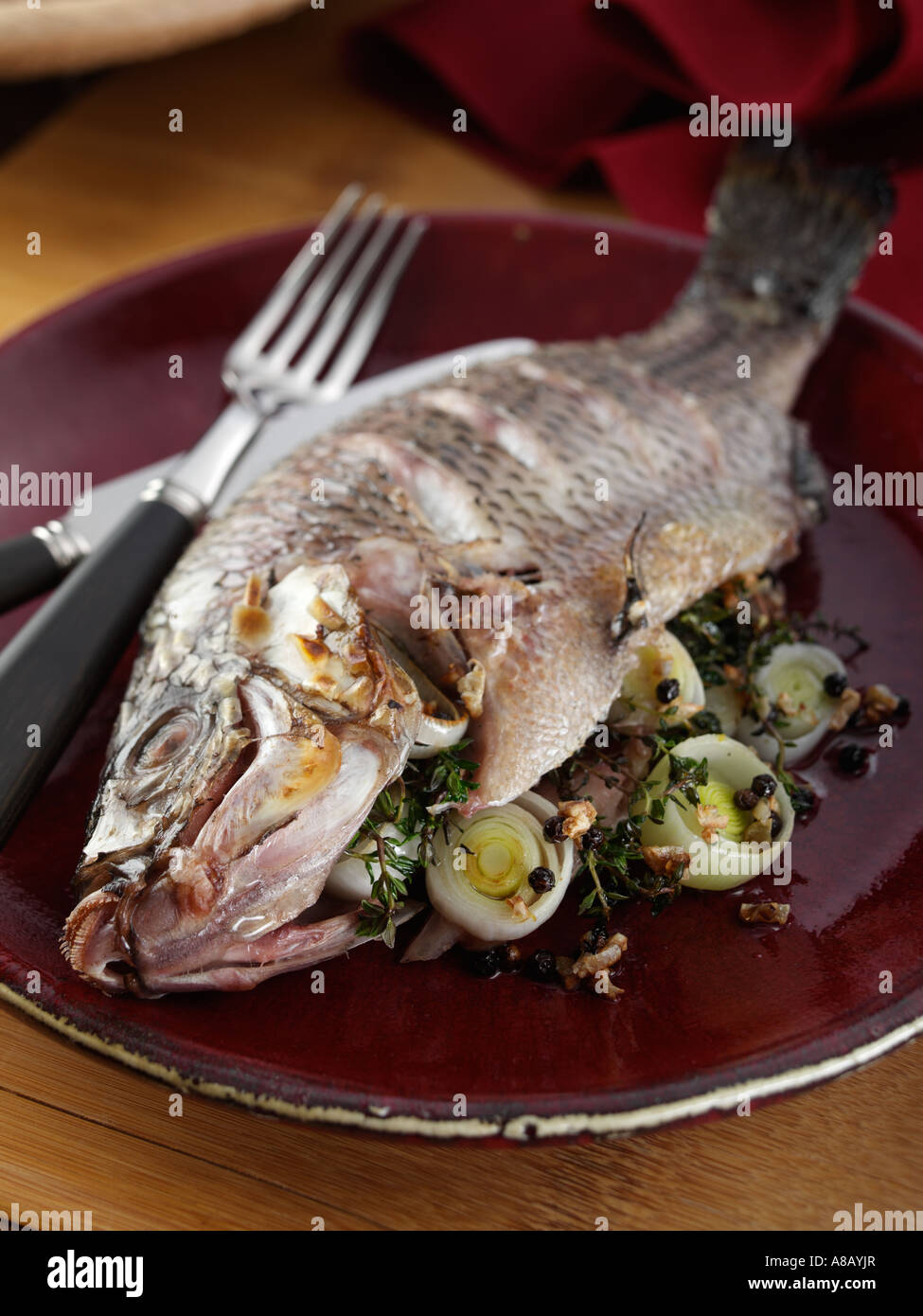 A plate of grilled stuffed tilapia fish editorial food Stock Photo - Alamy