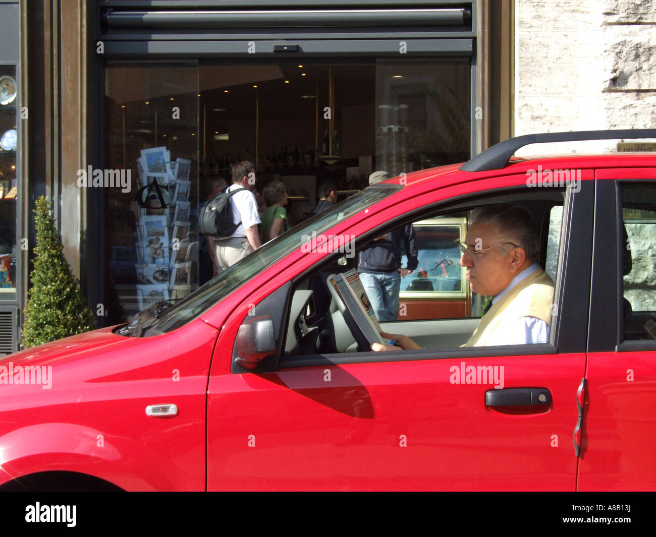 man reading paper in car in rome Stock Photo - Alamy