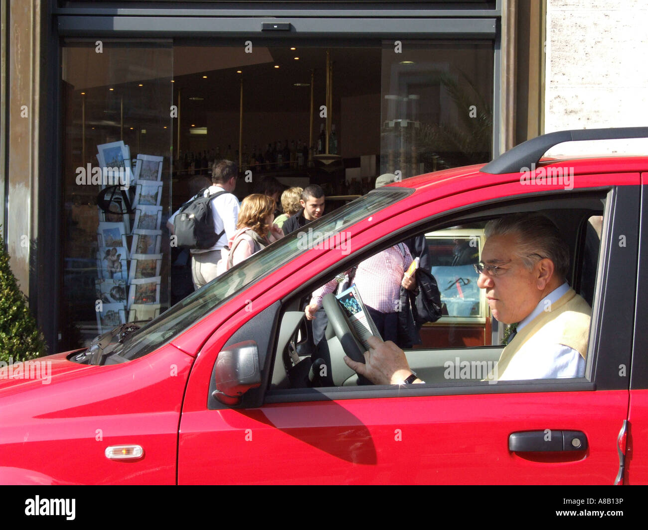 man reading paper in car in rome Stock Photo - Alamy