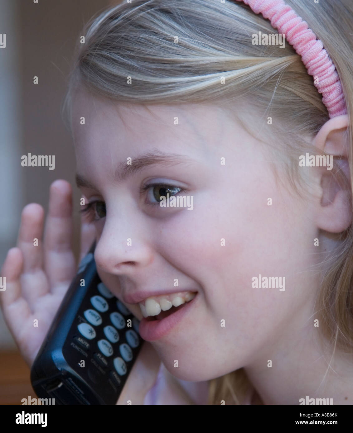 Child speaking on a telephone Stock Photo - Alamy