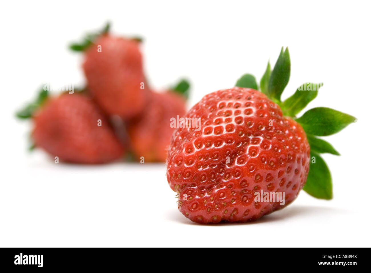 Bunch of Strawberries Front one focused Isolated on a white background ...