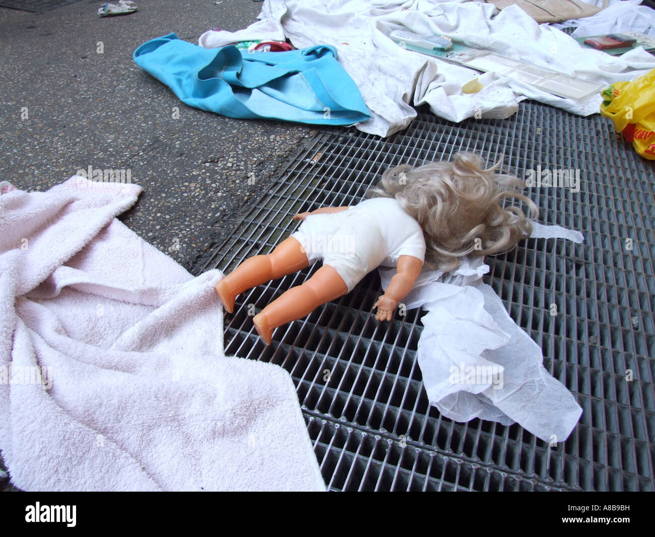 baby doll discarded in street Stock Photo - Alamy