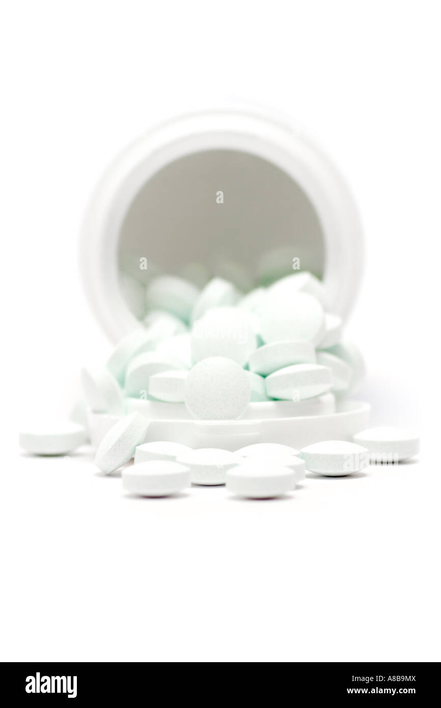 White tablets out of a plastic box Isolated on a white background ...