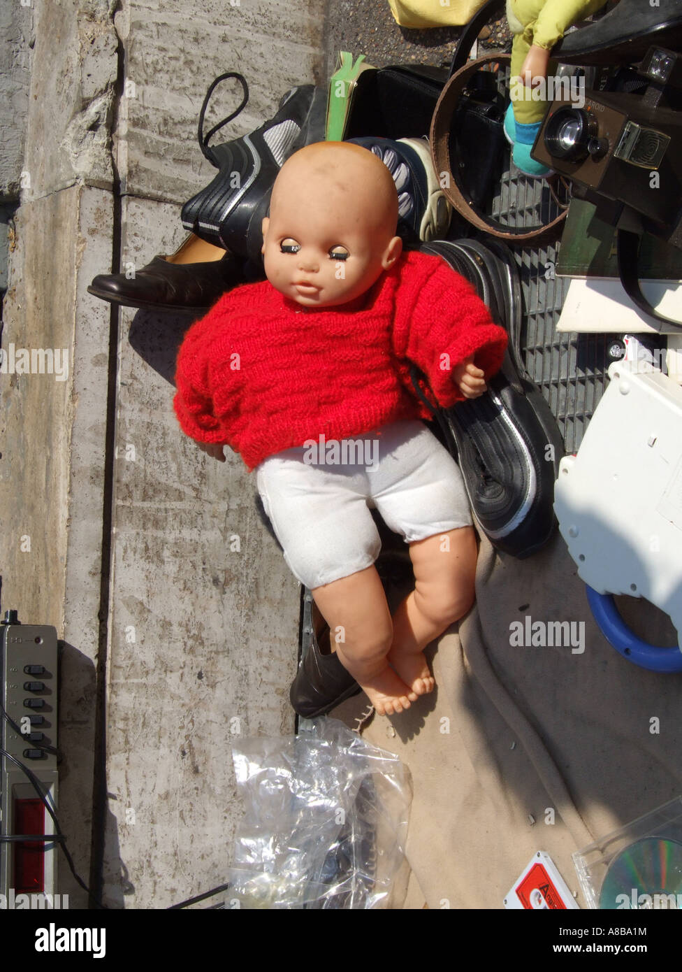 baby doll discarded in street Stock Photo - Alamy