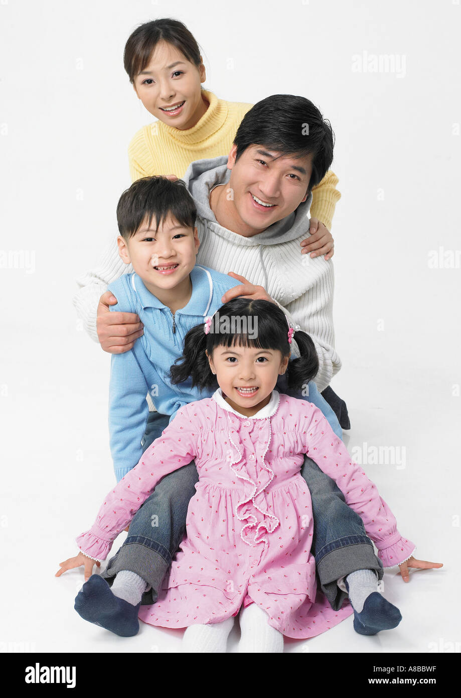 family members are sitting in a row Stock Photo - Alamy