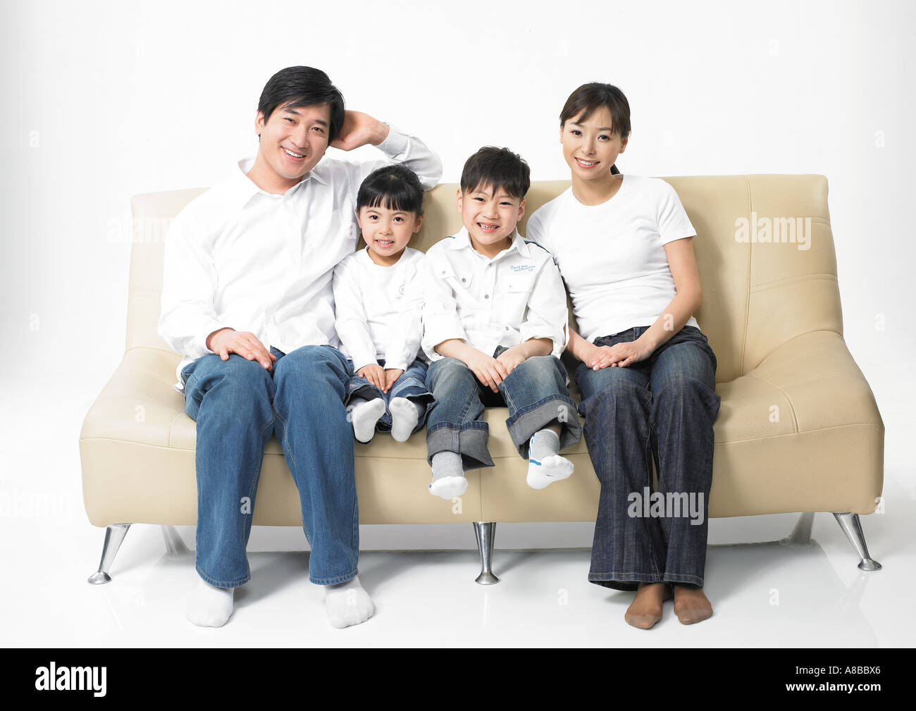 Family members sitting on couch hi-res stock photography and images - Alamy
