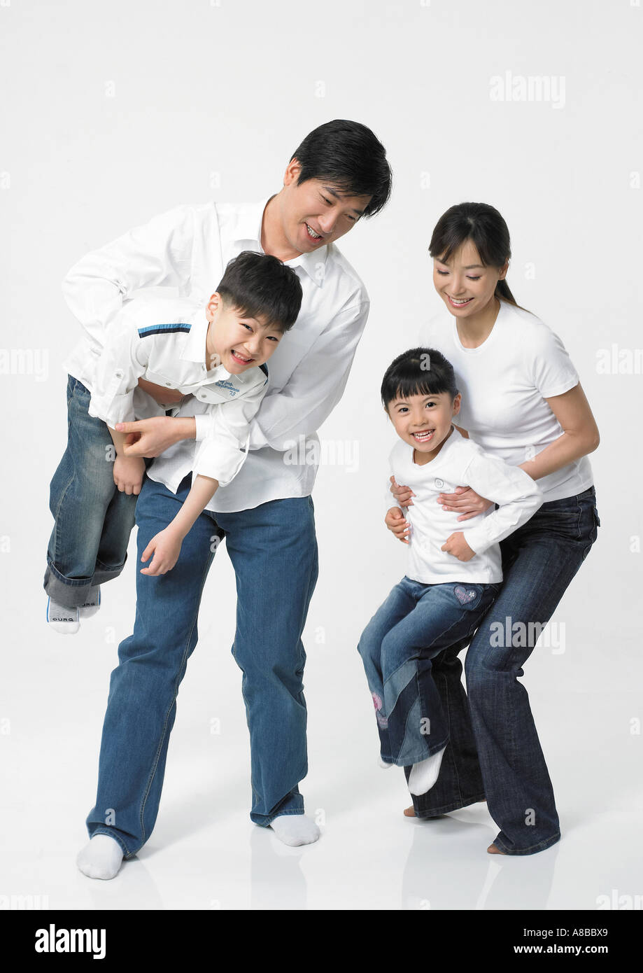 parents lift their child with a smile Stock Photo - Alamy