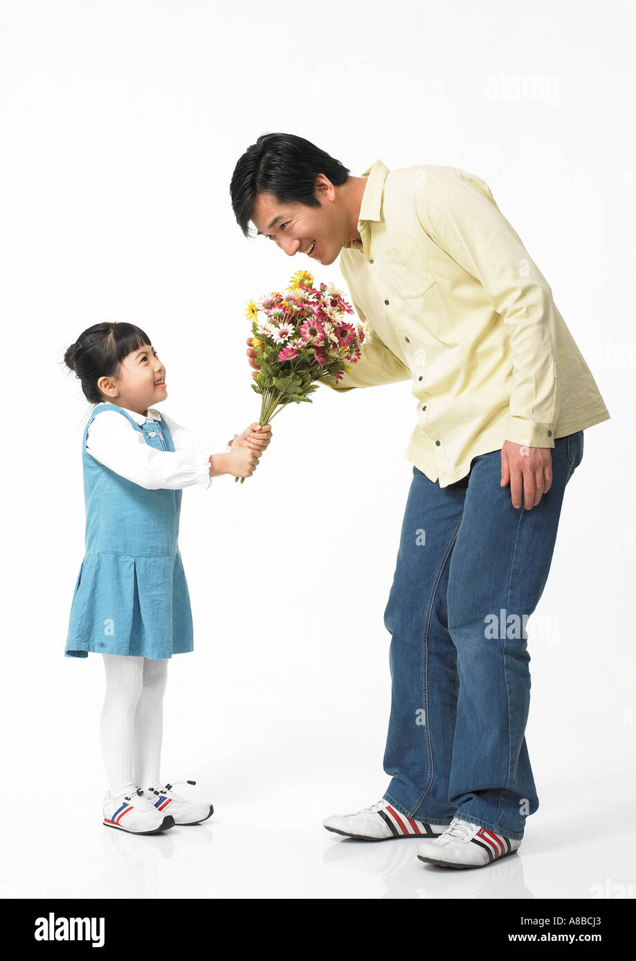 A girl gives a flower to her father Stock Photo - Alamy
