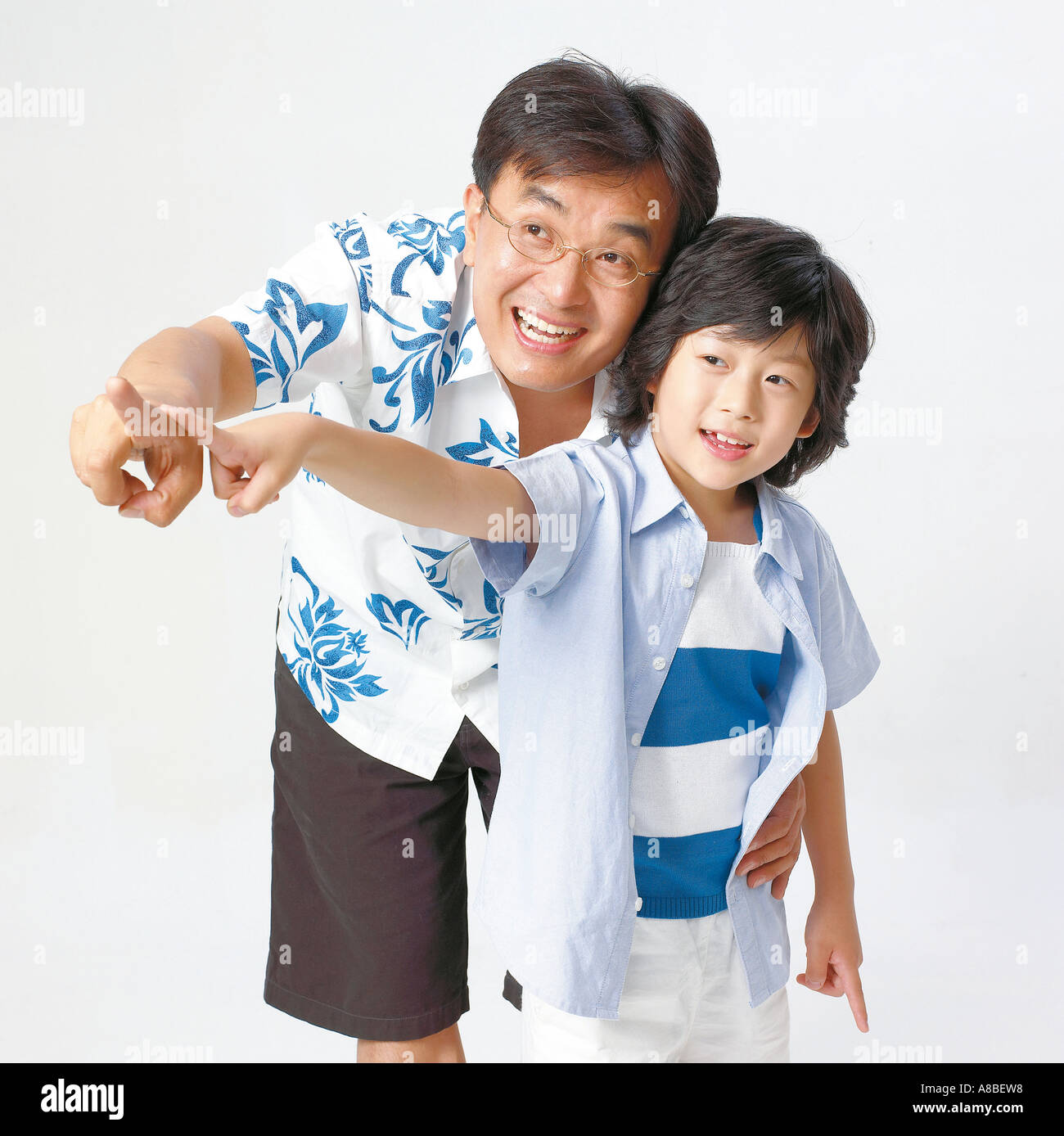 Father and son are posing with indicating Stock Photo - Alamy