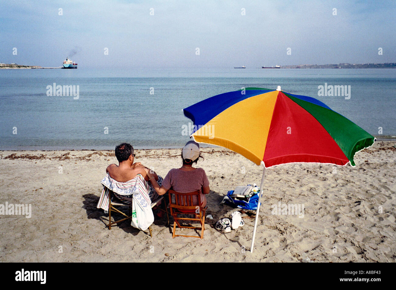 couple enjoy the sun on the beach of Priolo Sicily Stock Photo - Alamy