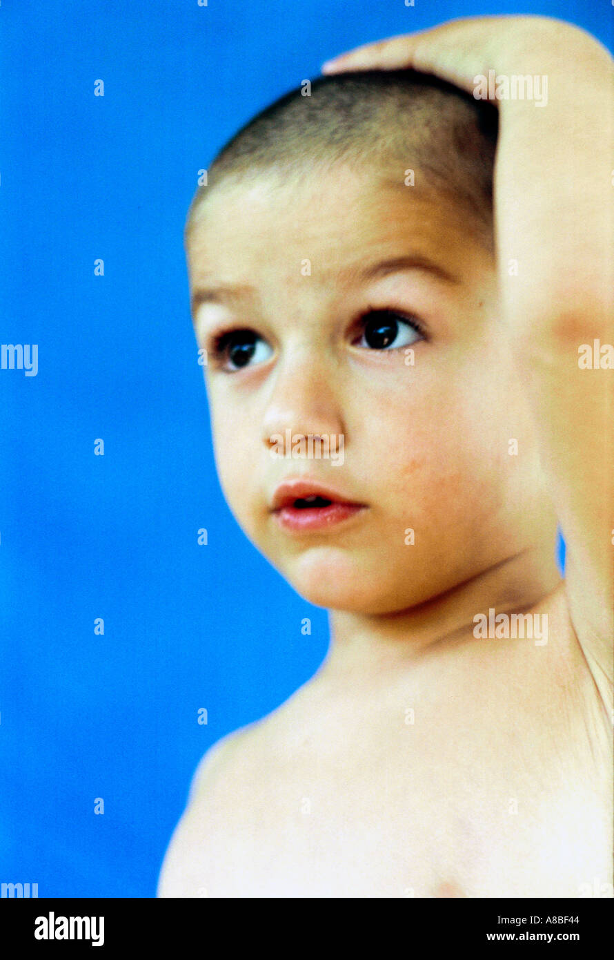 Portrait of a babyboy with shaven head Stock Photo - Alamy
