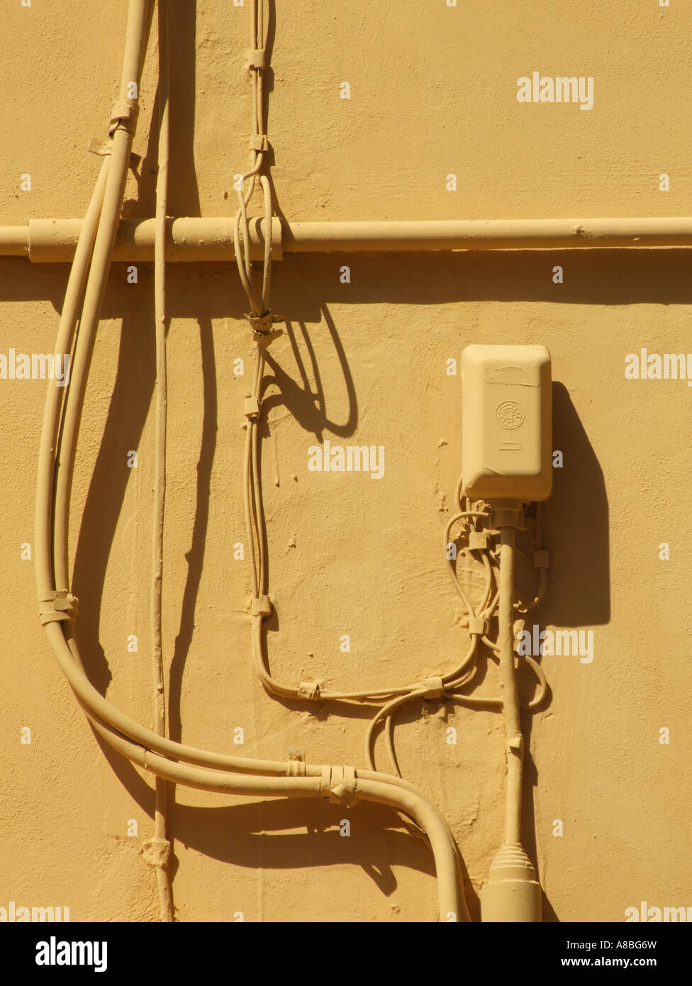 tangled wiring connections on property wall Stock Photo - Alamy