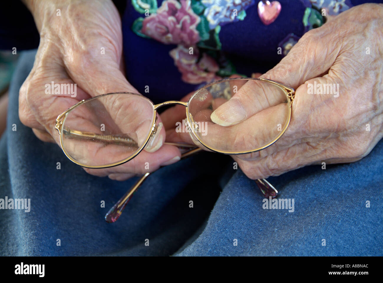 Ageing senior female with glasses in her hand Stock Photo - Alamy