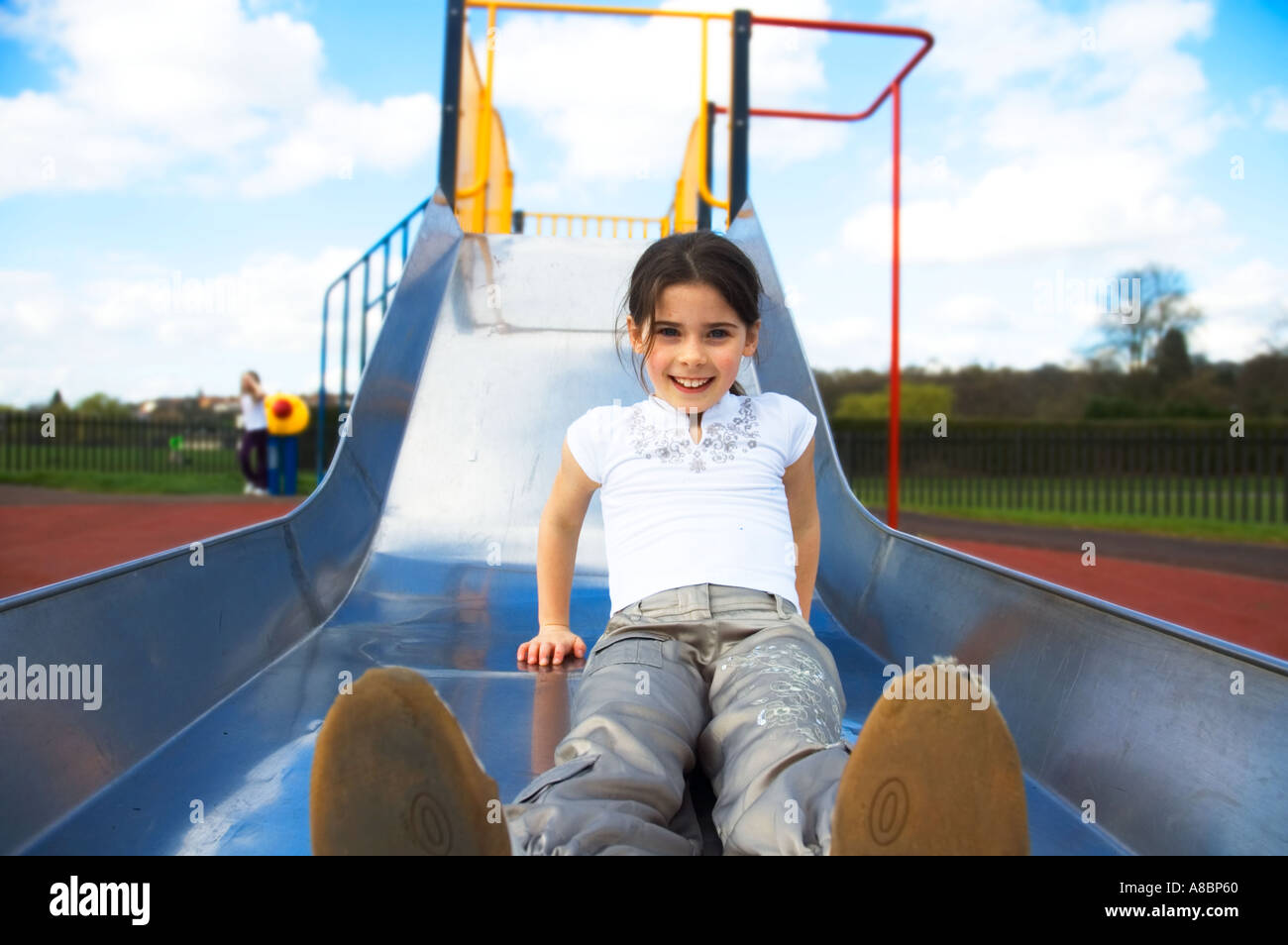 Young girl on slide in a park in England Stock Photo - Alamy