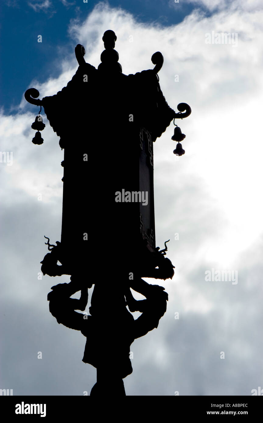 Silhouette of Chinese lamp post against blue sky with clouds Stock ...